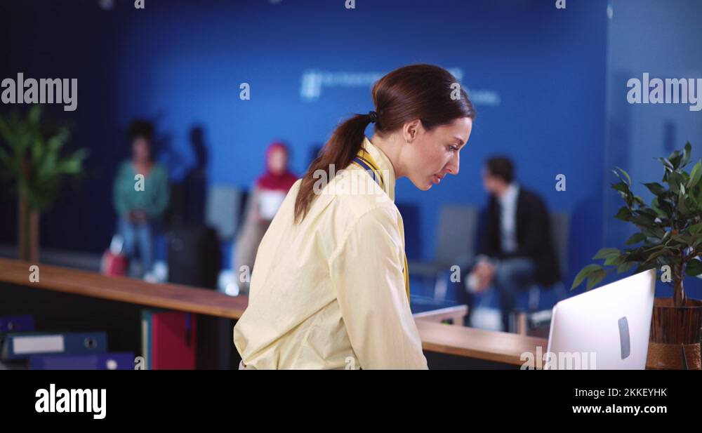 Attractive female security guard working by computer in the airport ...