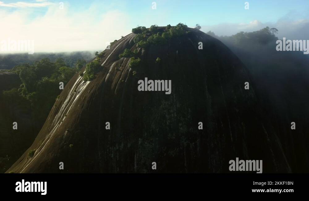 Voltzberg granite dome in Suriname jungle rainforest, dramatic aerial ...