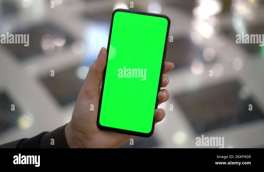 Handless csmera: Back view of female holding chroma key green screen ...