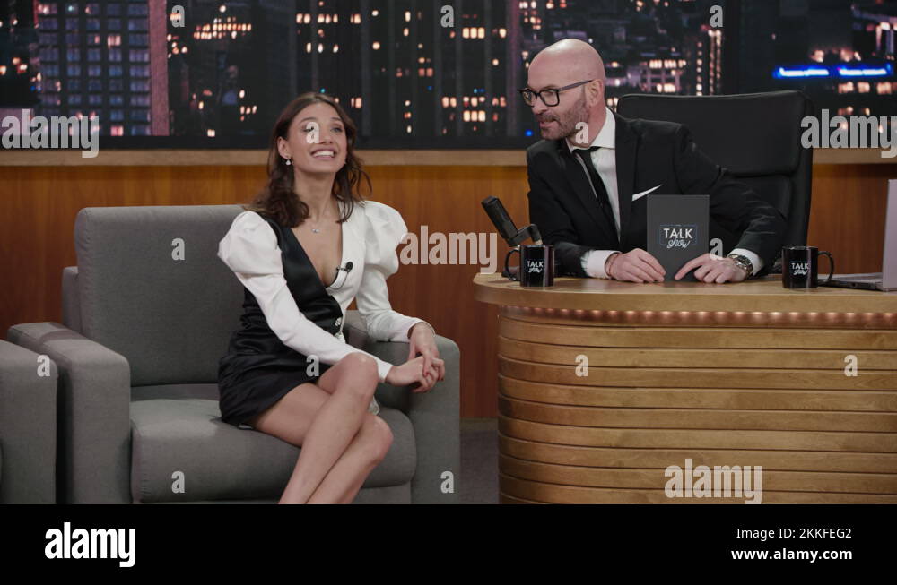 Late-night talk show host having a conversation with celebrity guest in ...