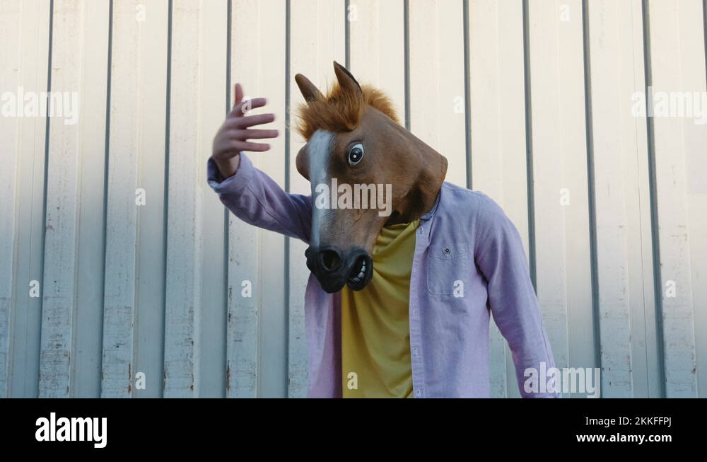 Dancing Funny Young Man in a Horse Mask Rhythmically Moving his arms Up ...