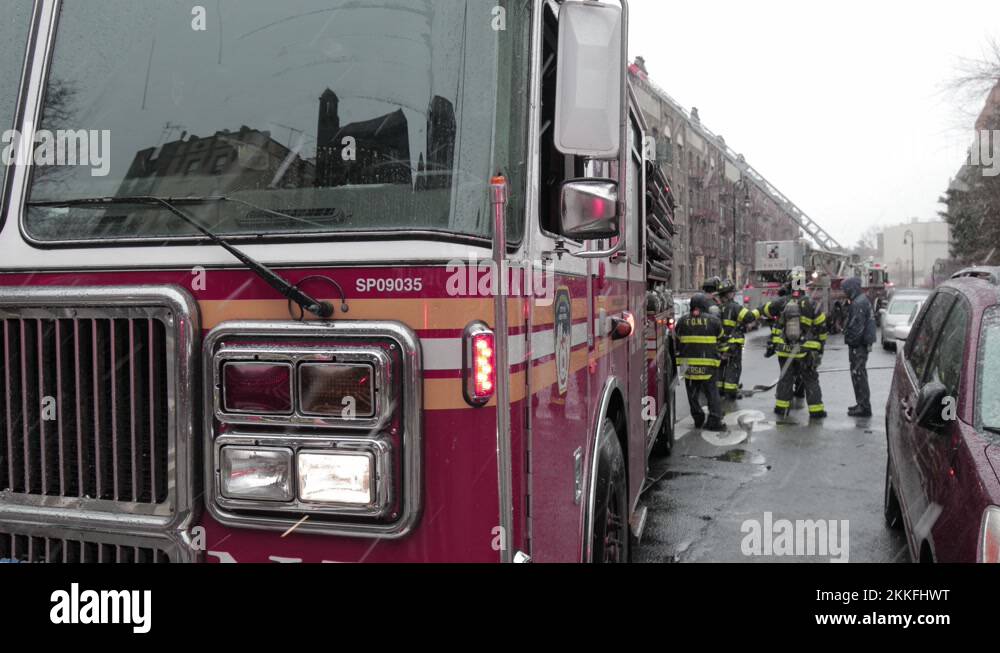 Fire Engine with flashing lights stationary on Brooklyn Street under ...