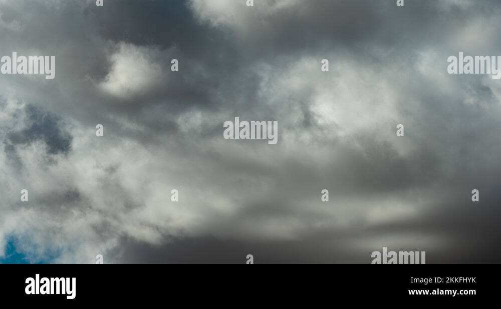 Large cumulus clouds passing overhead and forming into dark rain clouds ...