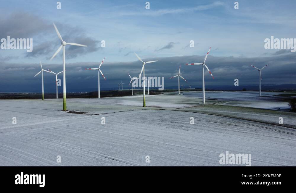 Wind turbines generating clean green energy on snowy wind farm in Stock ...