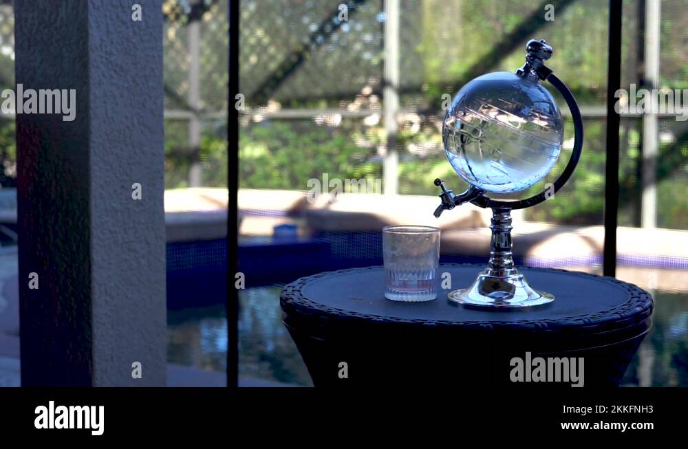 Glass Globe holding a 5th of Vodka Stock Video Footage - Alamy