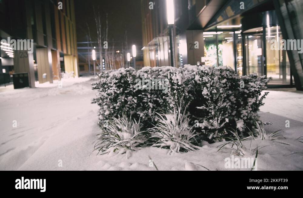 Night city space view. Snow-covered city square in lights of an office ...