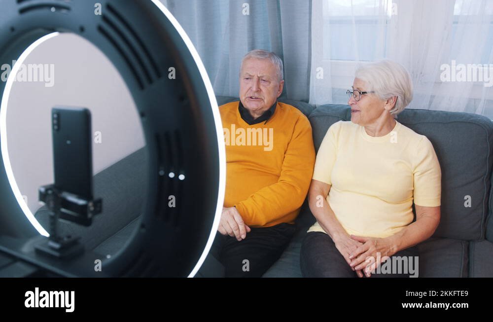 Elderly couple giving an interview or recording video message for ...