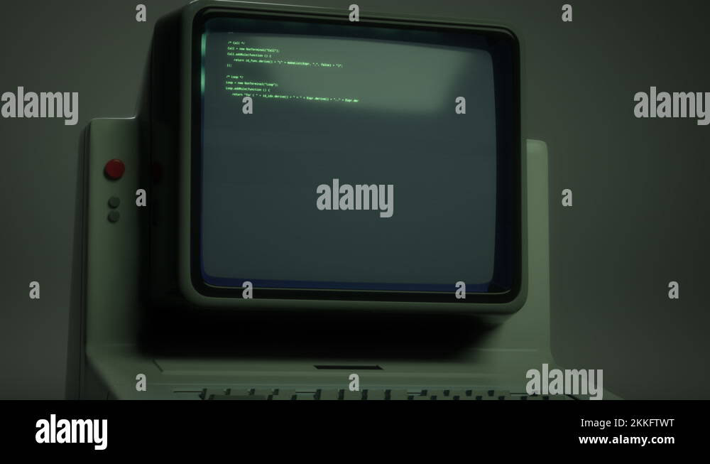 Retro personal computer or PC with source code displayed on monitor ...