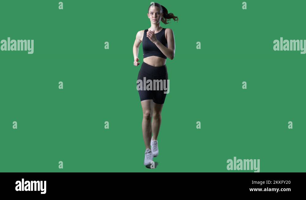 Fit sportswoman jogging in sporty clothes. Full body on chroma key ...