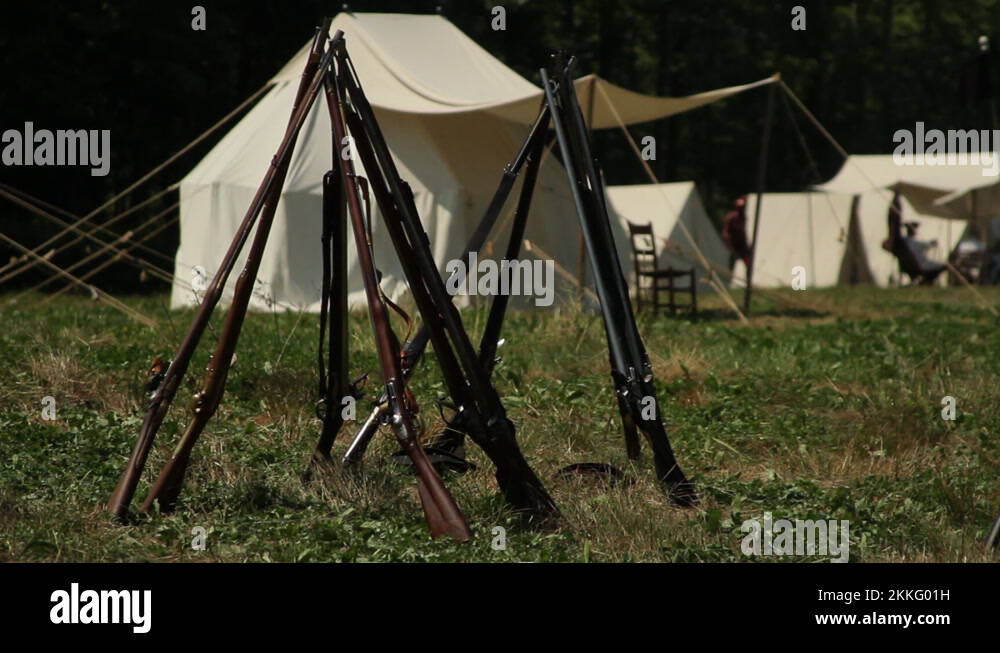 Re-enactment Soldier Tent Camp with a musket stack, soldiers & flags ...