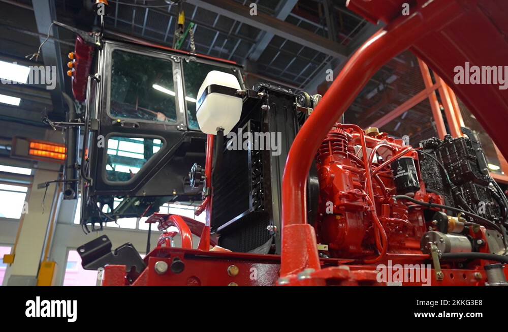 The tractor cab is suspended in the workshop on a crane beam, the ...