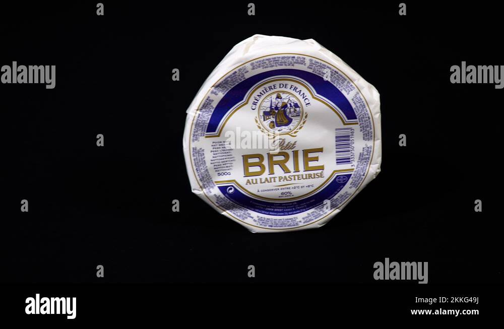 Brie cheese is a famous French cheese. Dolly shooting on a black ...