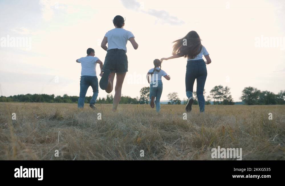 Happy family in the team mom dad children, kids run together in the ...