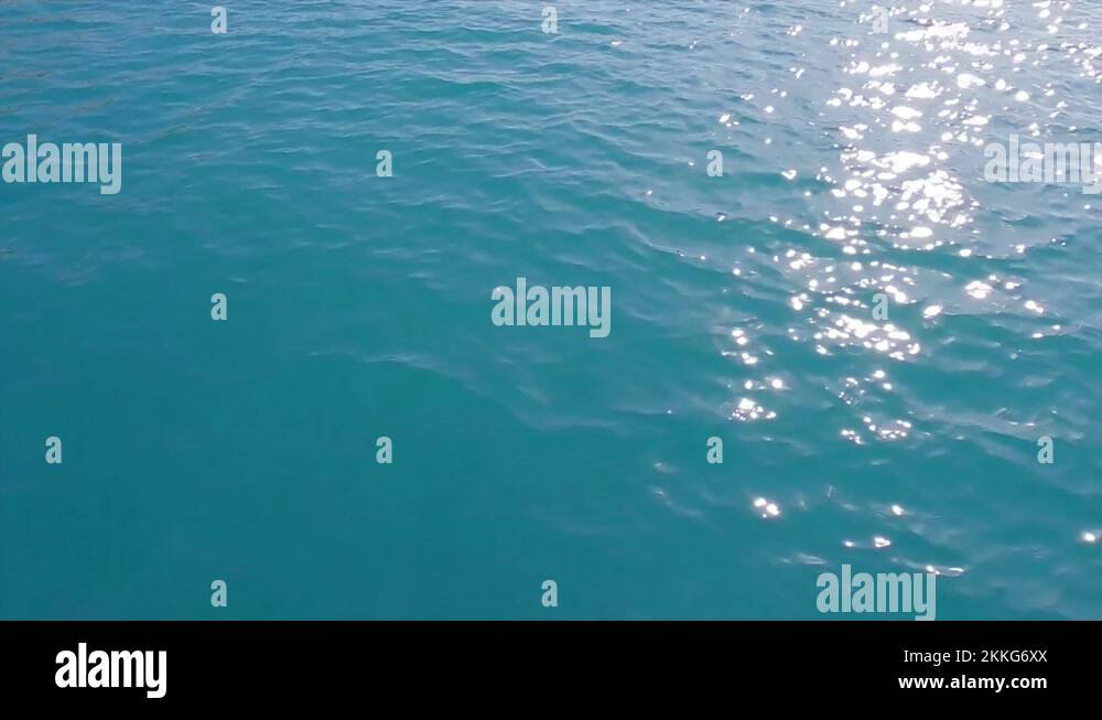Bright shiny sun glare reflection on deep blue sea water surface n ...