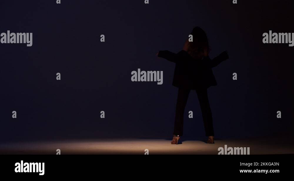 Model at the studio is posing in a jacket, low lighting, spotlight, 4k ...