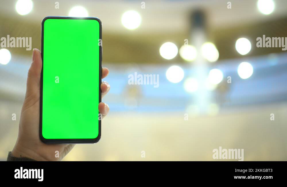 Handless csmera: Back view of female holding chroma key green screen ...