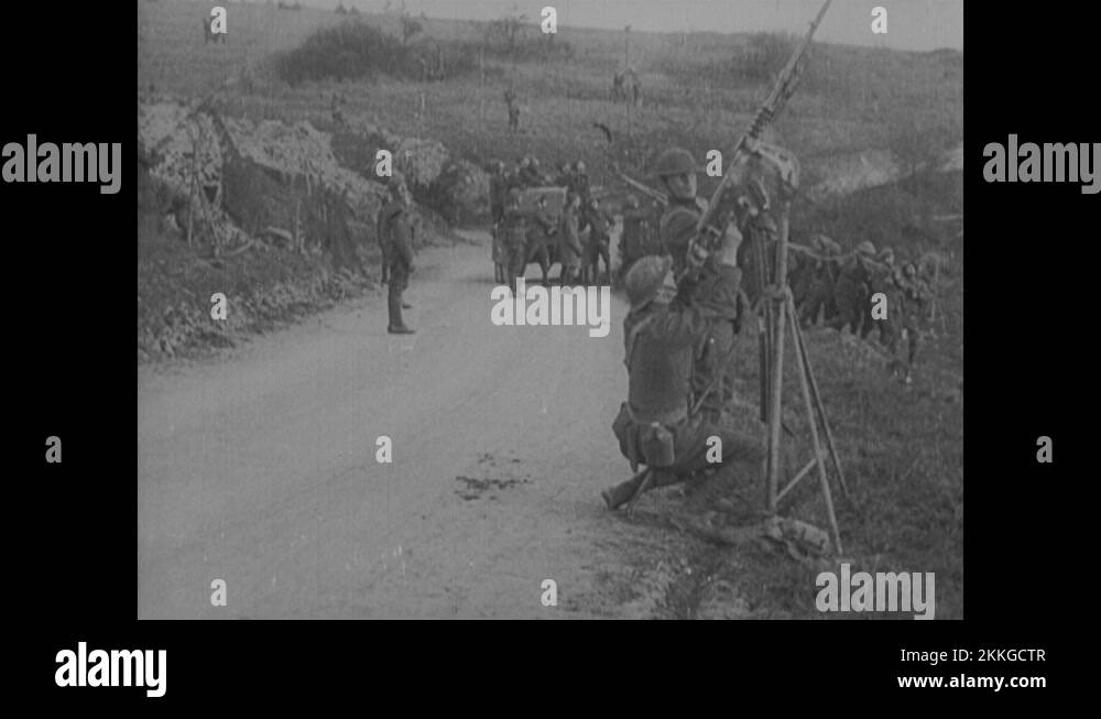 1910s: Airplane flies across sky. Soldier on ground fires mounted ...