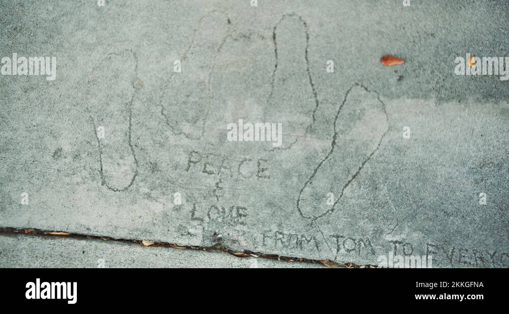 Outline of Feet, Peace and Love Written in Concrete Cement Street Art ...