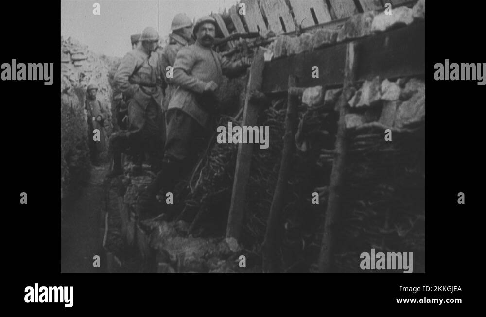 1910s: Soldiers in line looking over top of trench. Soldiers in trench ...