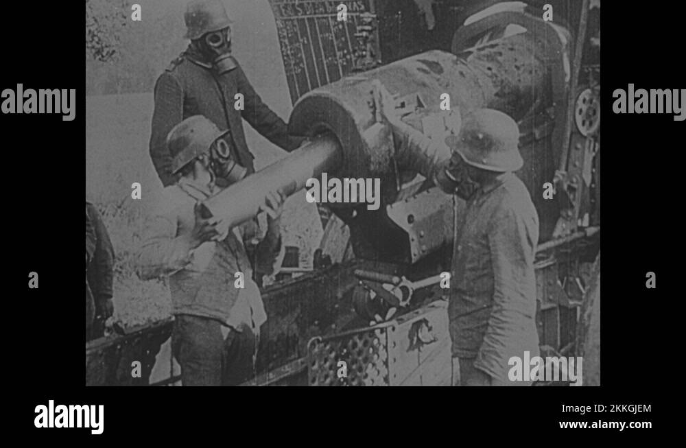 1910s: Newspaper headlines. Men in gas masks load capsule into cannon ...