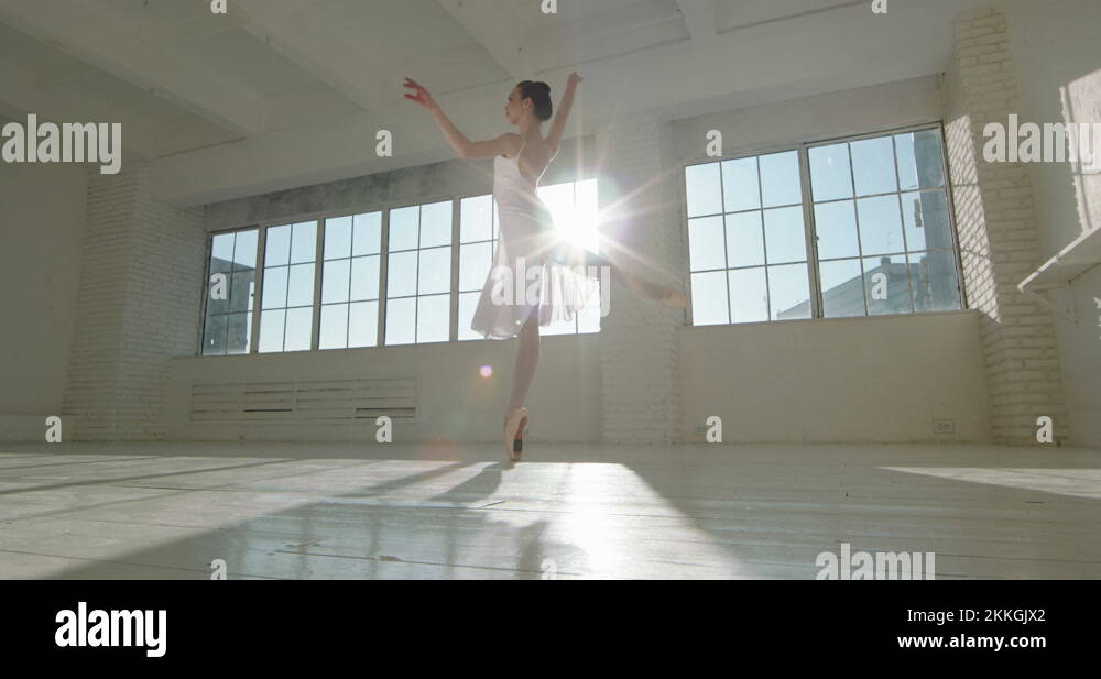 Graceful talented caucasian ballet dancer practicing her moves in ...