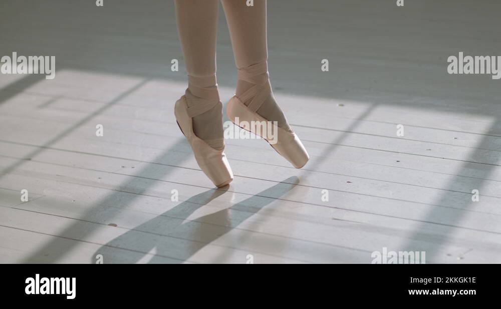 Ballerina standing on tip-toes. Ballet dancer wearing pointe shoes ...