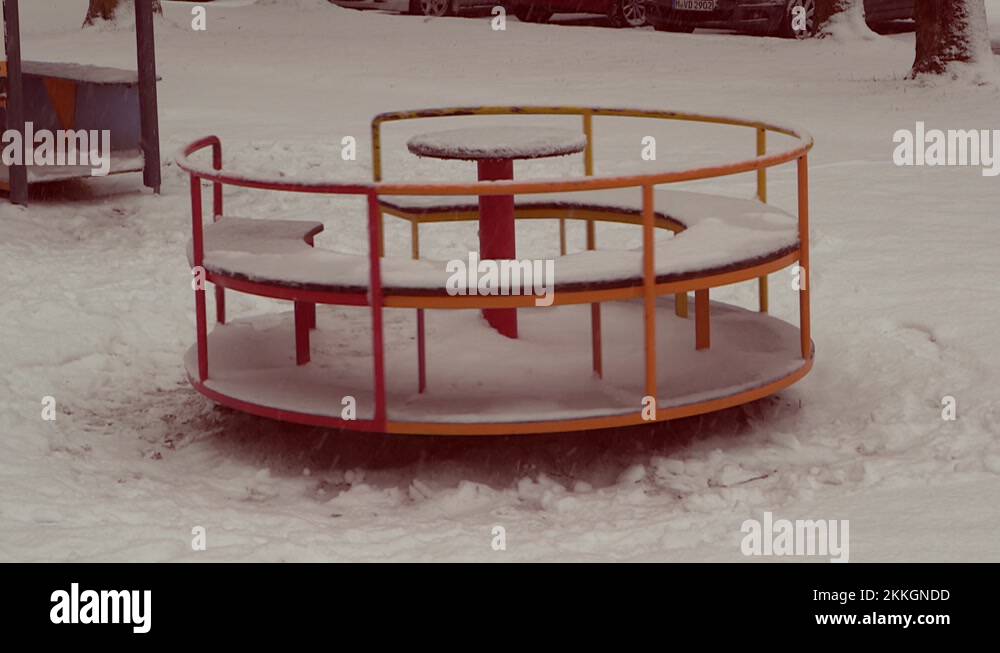 Empty carousel turning in the snow Stock Video Footage - Alamy