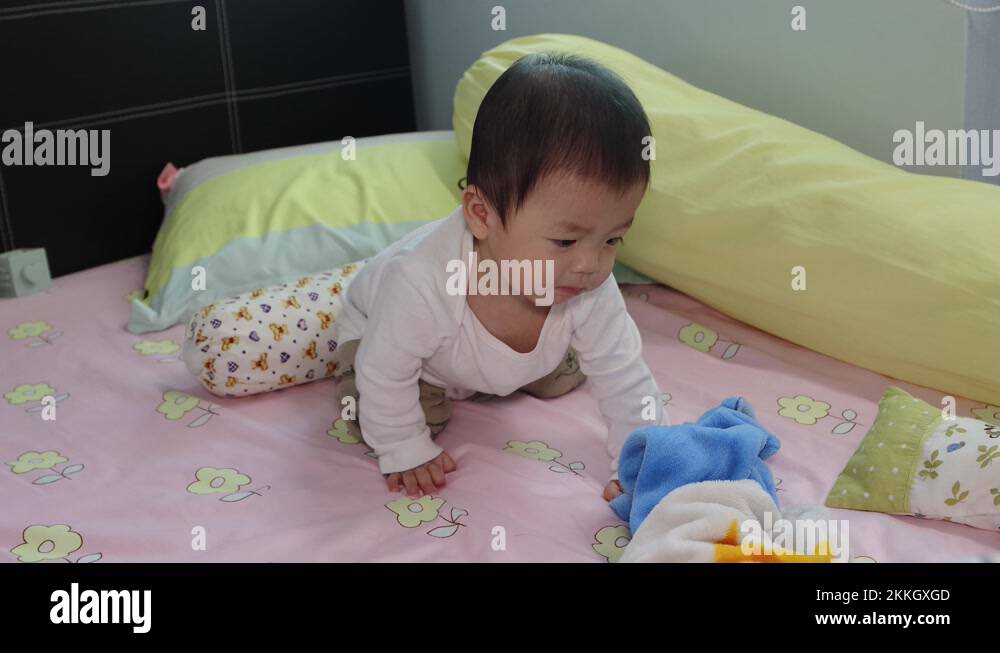 portrait of 8 month Asian Chinese baby boy looks and move around ...