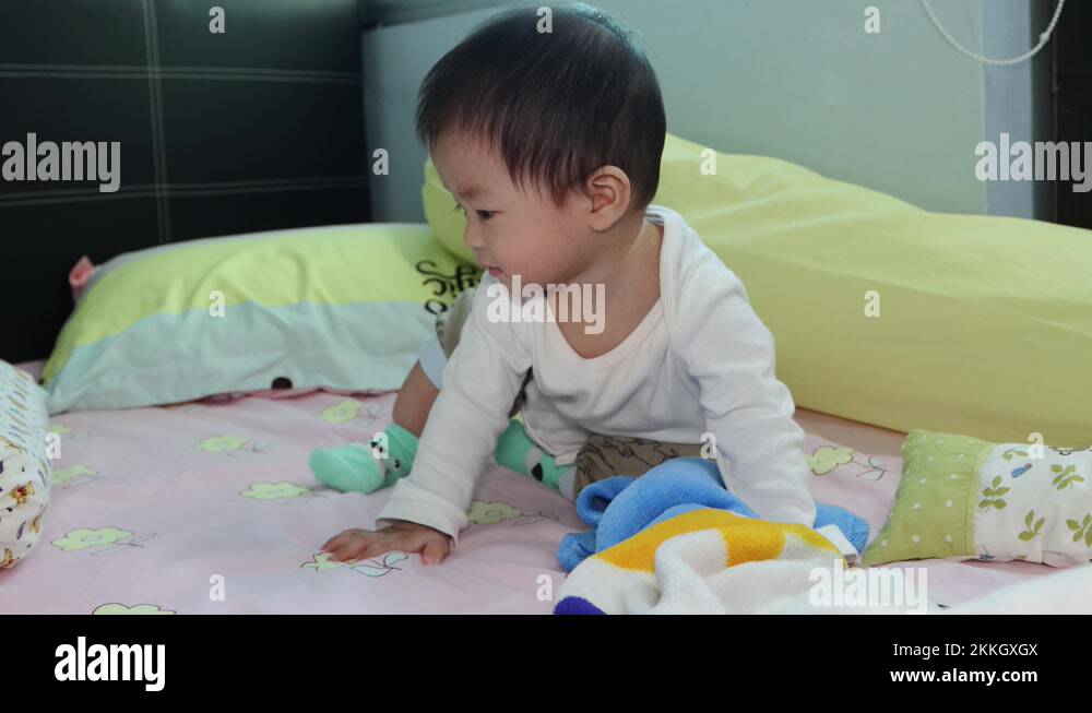 portrait of 8 month Asian Chinese baby boy looks and move around ...