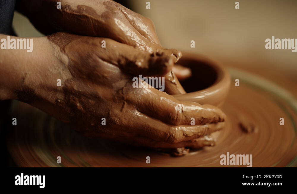 Woman hands sculpting clay product in workshop. Lady modeling pot in ...
