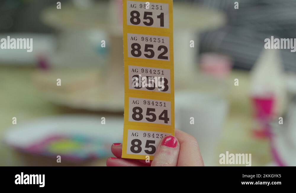 Lady Holds Up A Raffle Ticket With Multiple Numbers Stock Video Footage lady-holds-up-a-raffle-ticket-with-multiple-numbers-stock-video-footage