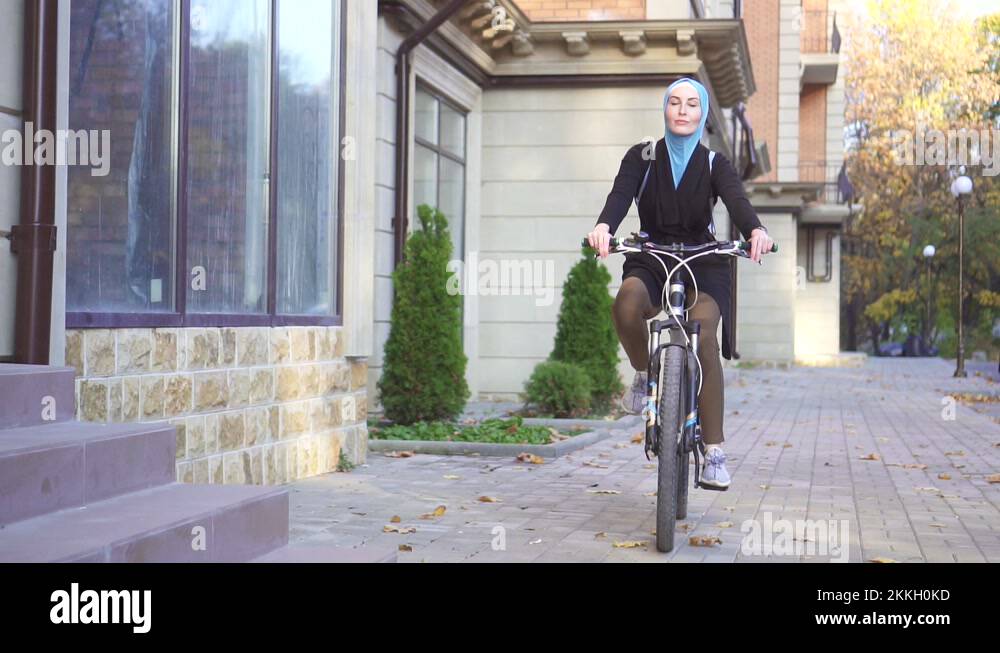 beautiful muslim woman in hijab rides a bicycle in the city Stock Video ...