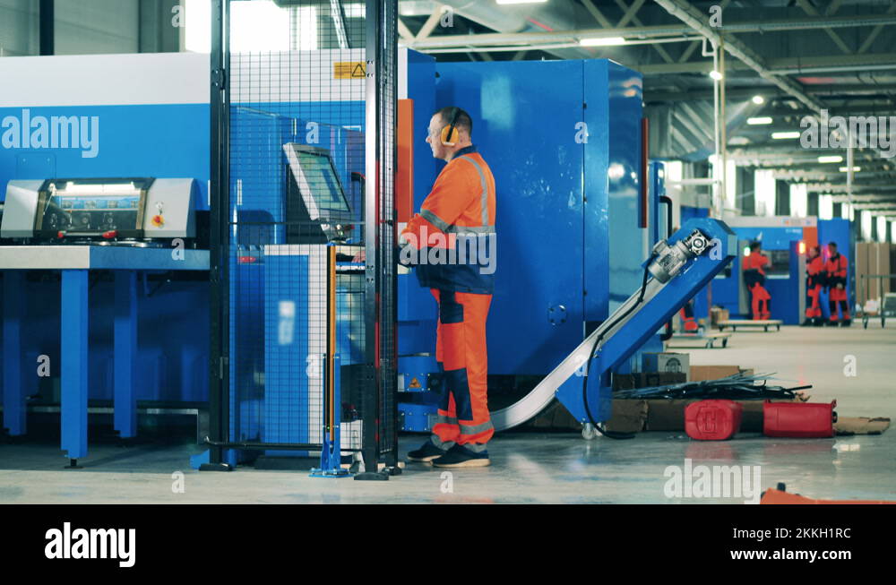 Engineer working on an assembly line at a modern industrial factory ...