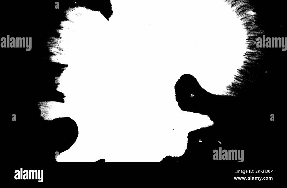 Drop white ink spreads over the center of the black background .Ink ...