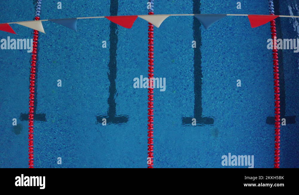 Flying above the lanes of the swimming pool. Aerial view of transparent ...