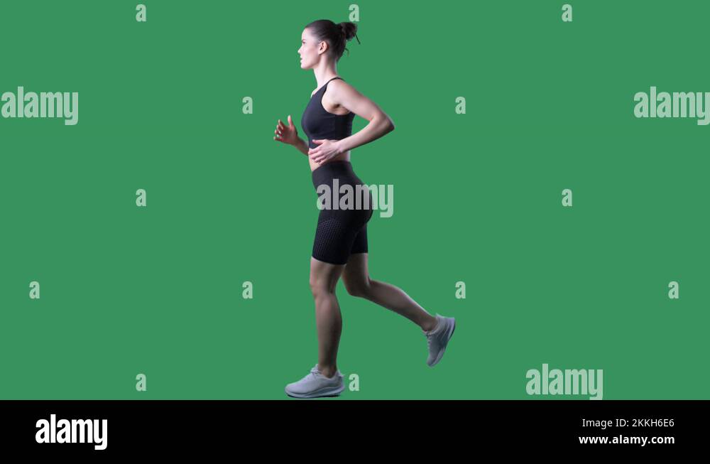Side view of active fit woman running in slow motion. Full body on ...