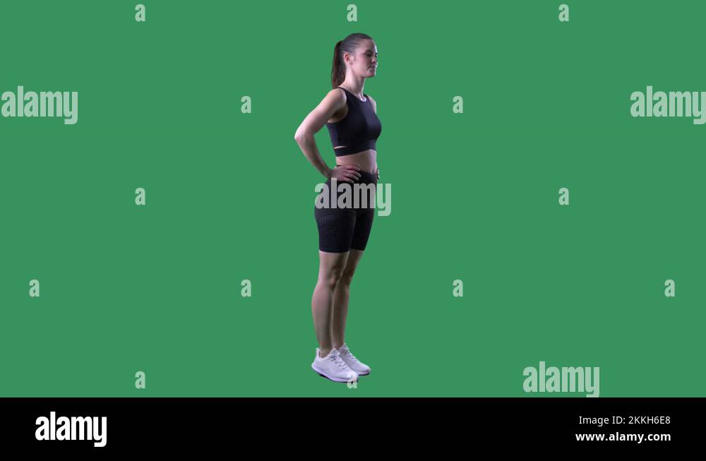 Side view of woman leg stretching exercises. Full body on key green ...