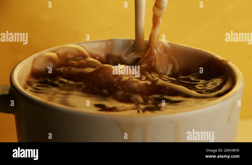 Cream pouring into coffee in slow motion Stock Video Footage - Alamy