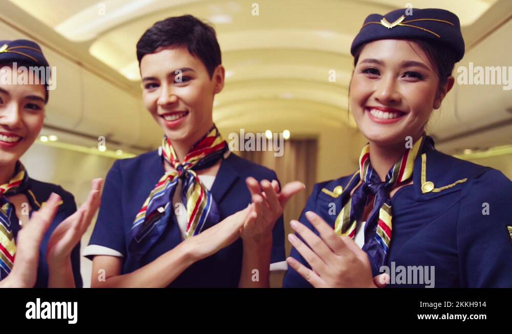 Cabin crew clapping hands in airplane Stock Video Footage - Alamy