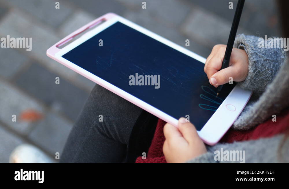 Concentrated little girl drawing stick figures on a tablet Stock Video ...