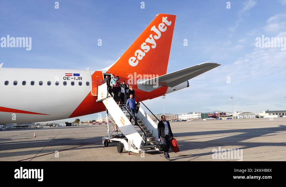 People passengers descending the steps staircase of the Airbus A320-214 ...