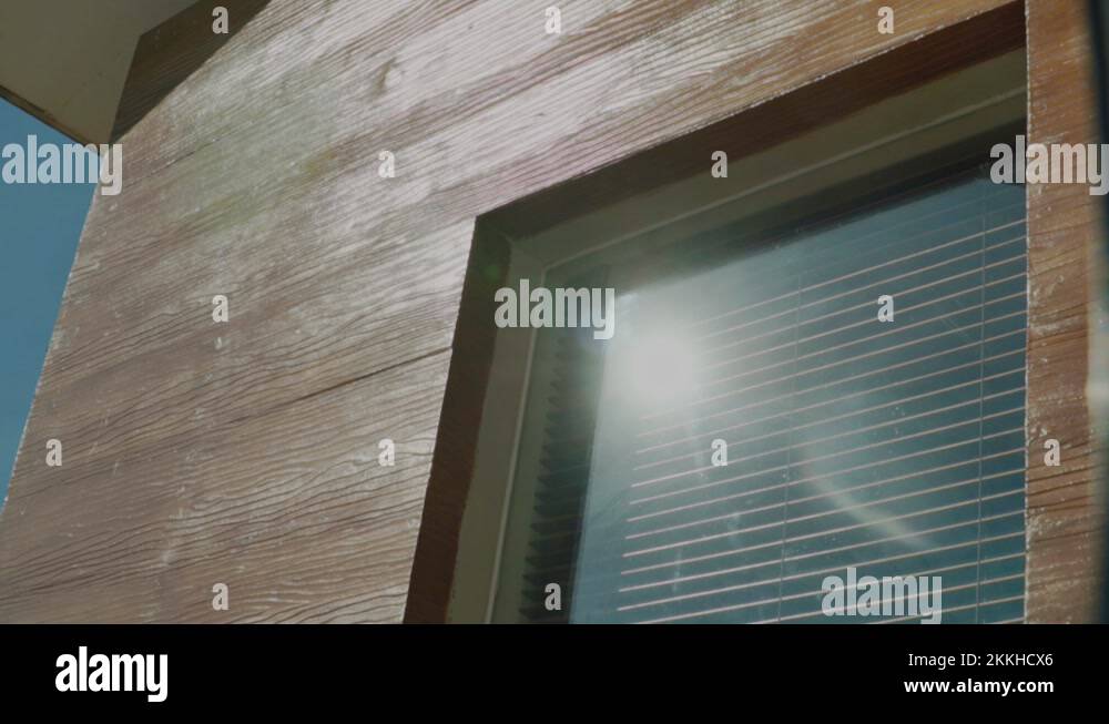 Sunlight flare on window, reflection on window's house in the outside ...