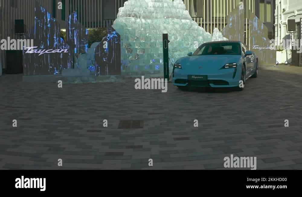 Frozen blue color Porsche Taycan Turbo S charging showroom. Ice brick ...