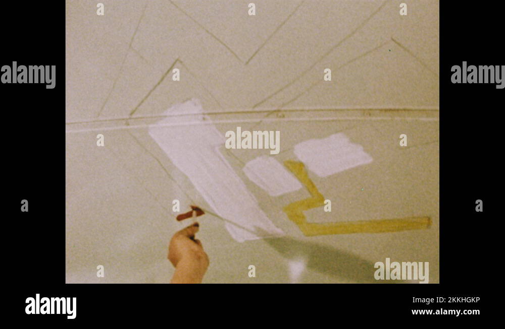 1970s: Girl paints wall of school bus. Boy paints ceiling of school bus ...