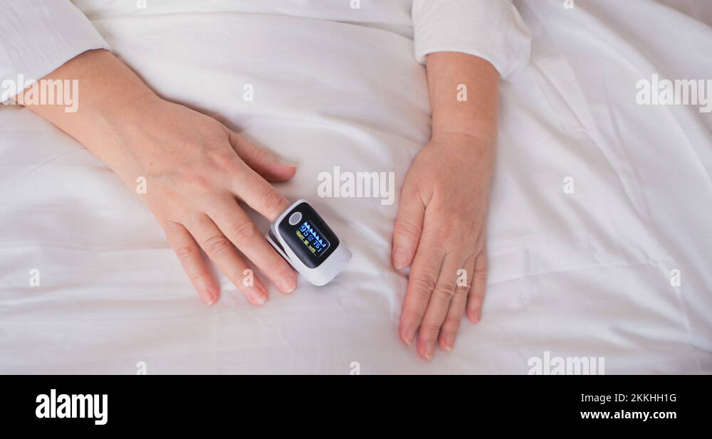 Pulse oximeter at home or clinic show blood oxygen saturation level and ...