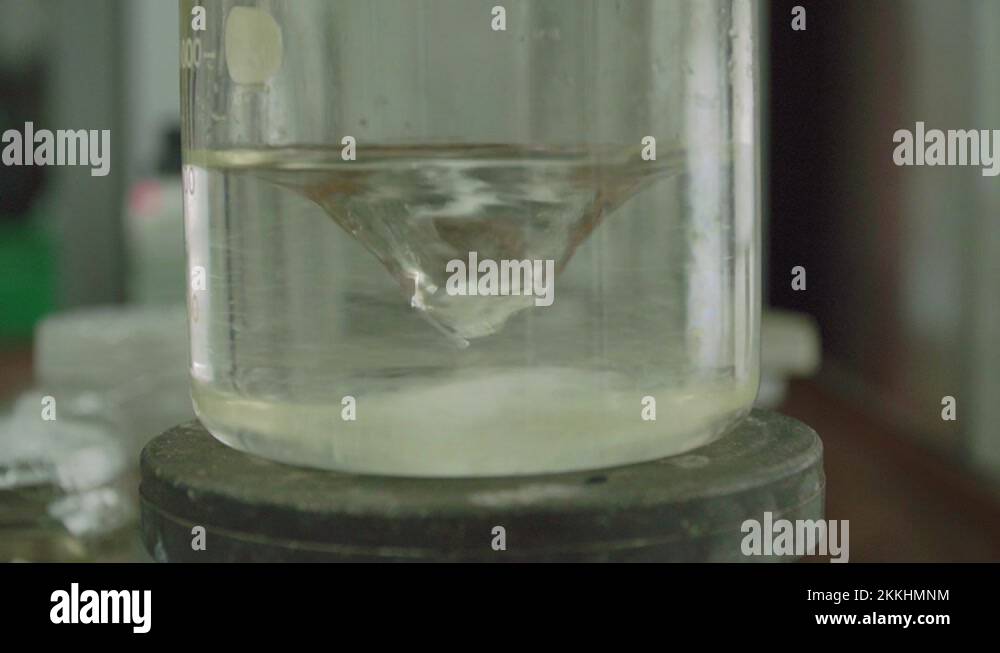 Close up of Pure water Swirl in Lab glass beaker in chemical laboratory ...