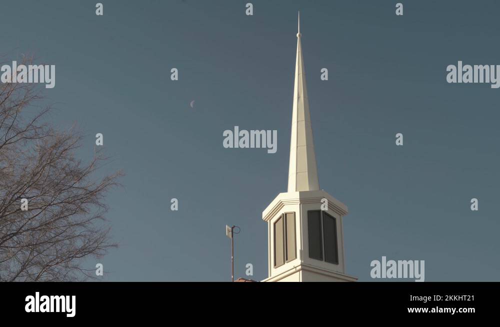 Bird Flies in front of Mormon Church Building Spire with Faint Half ...