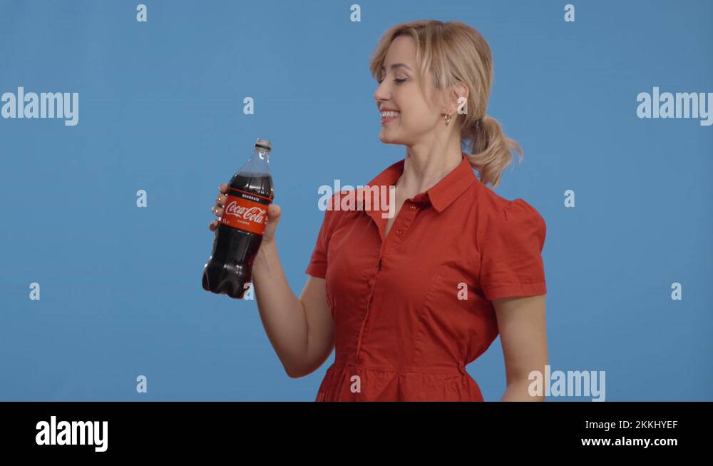 Young woman drinking Coca Cola -Zero Sugar and being happy to cool off ...