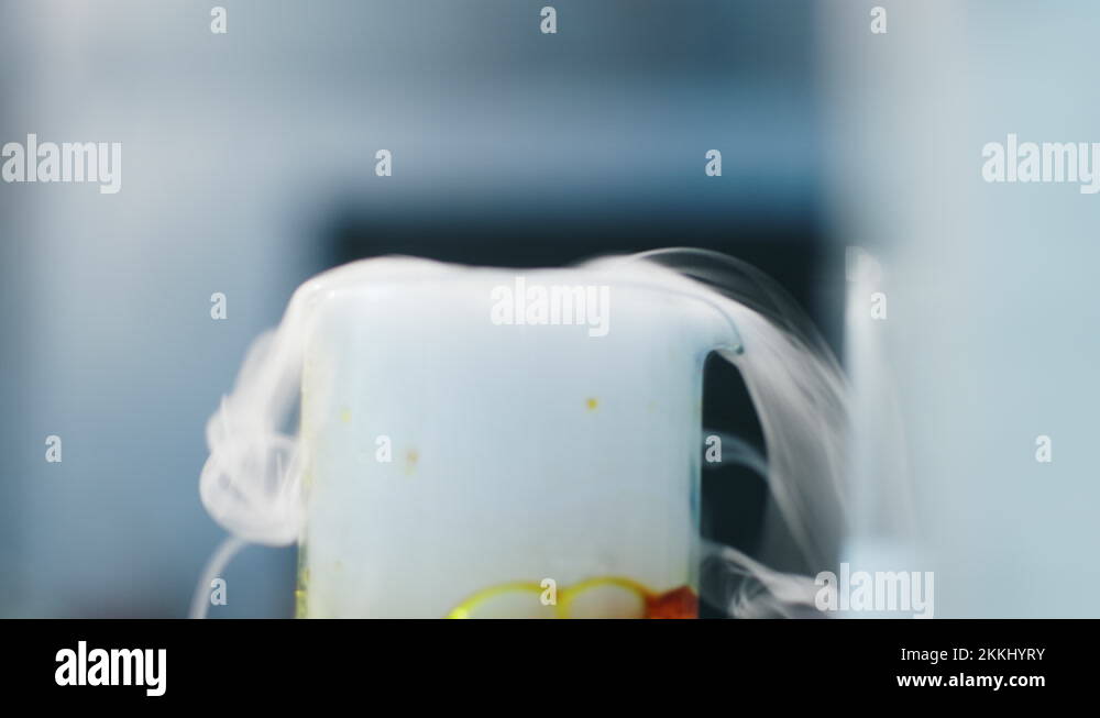 Details closeup boiling yellow substance from the flask in the ...