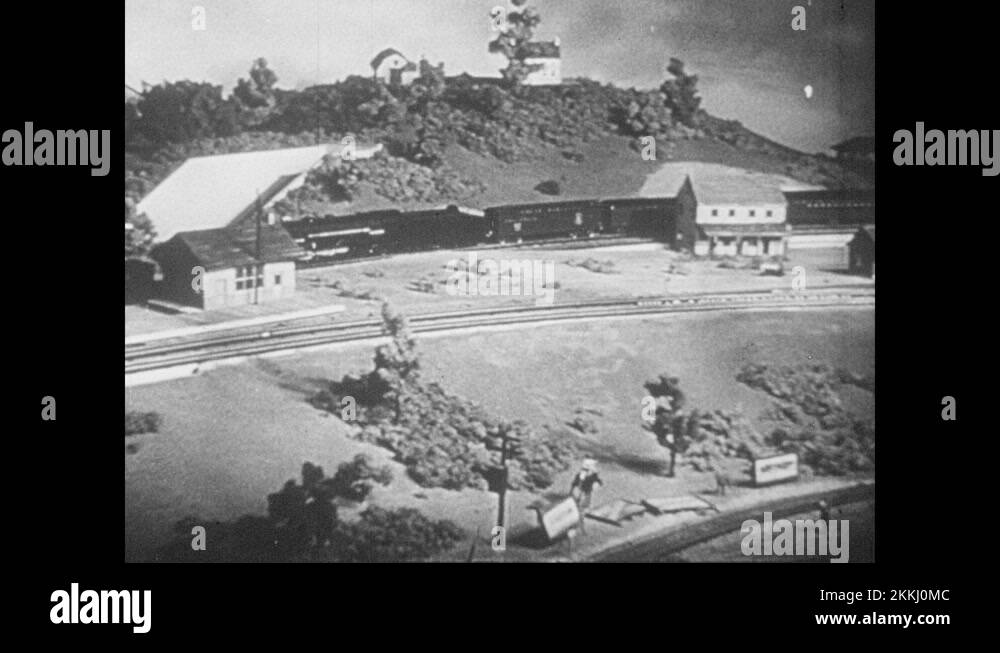 1950s: Model trains run on track through layouts. Smoke wisps out of ...